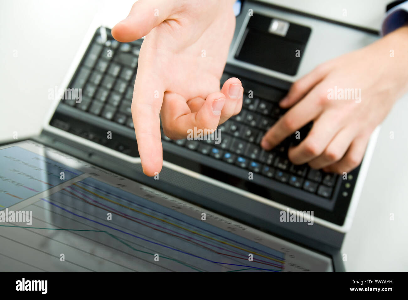 Above angle of male hand with forefinger pointing at laptop screen on ...