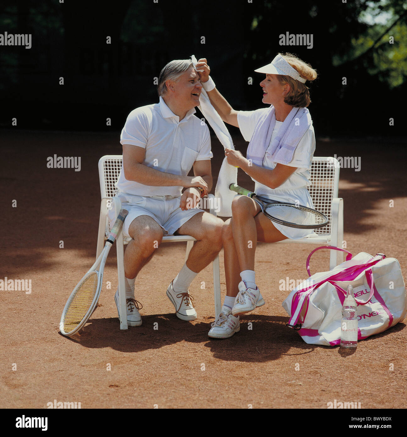 tennis sport seniors pair couple middle age old person break stop rest ...