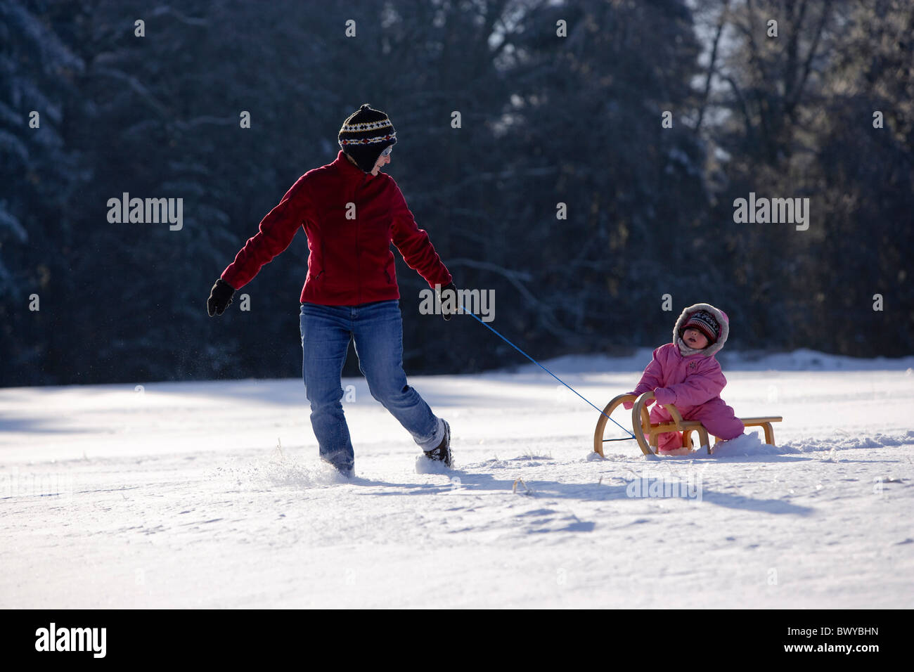 Two children pulling sledges hi-res stock photography and images - Alamy