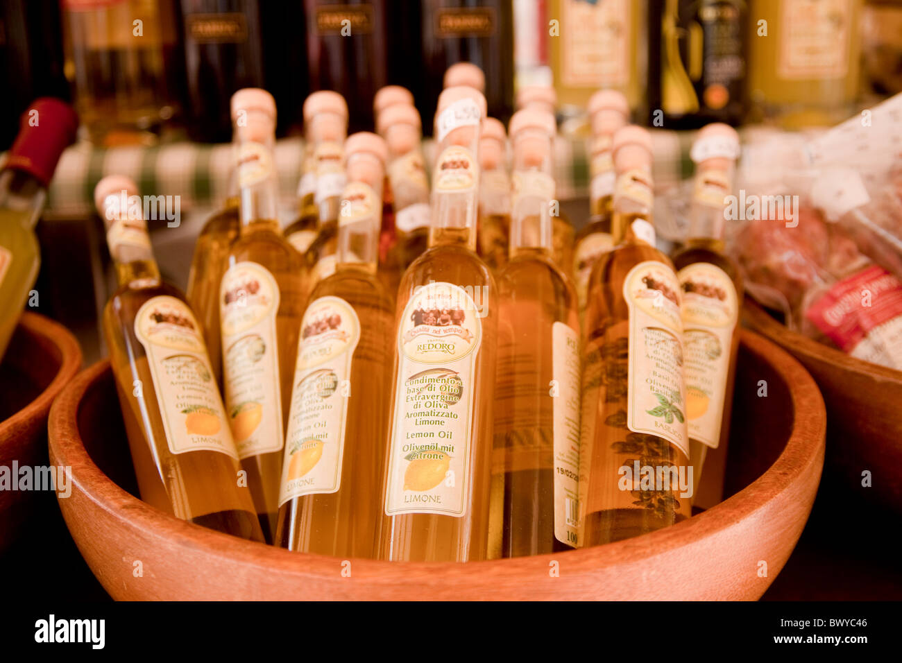 Large bowl containing bottles of food oil on display in shop window in ...