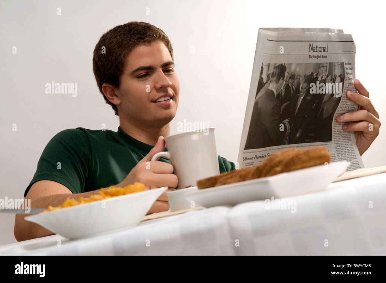 Man having breakfast, reading the newspaper Stock Photo - Alamy