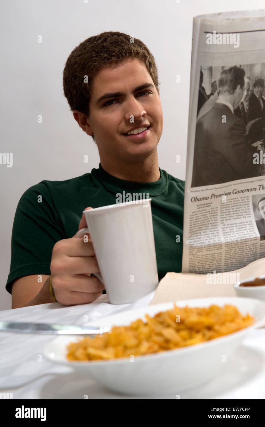Man having breakfast, reading the newspaper Stock Photo - Alamy