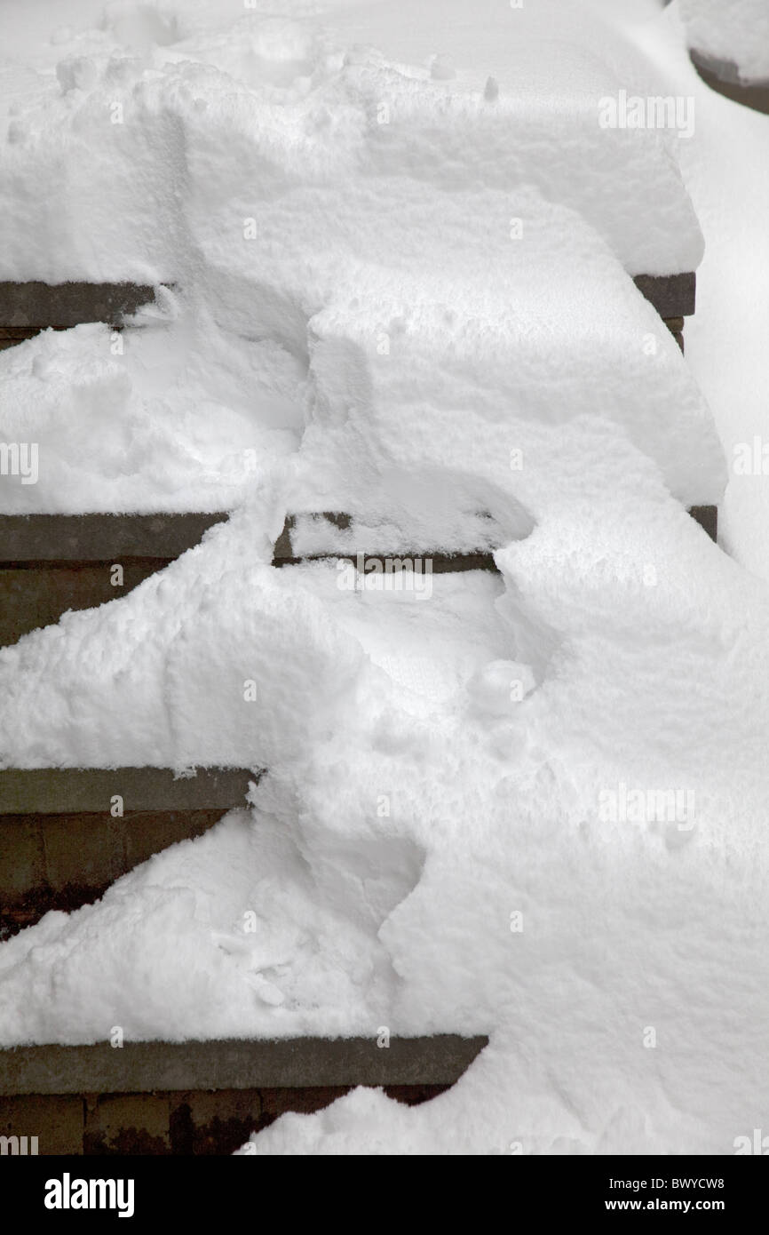 Steps covered in deep snow showing footprints, UK Stock Photo - Alamy