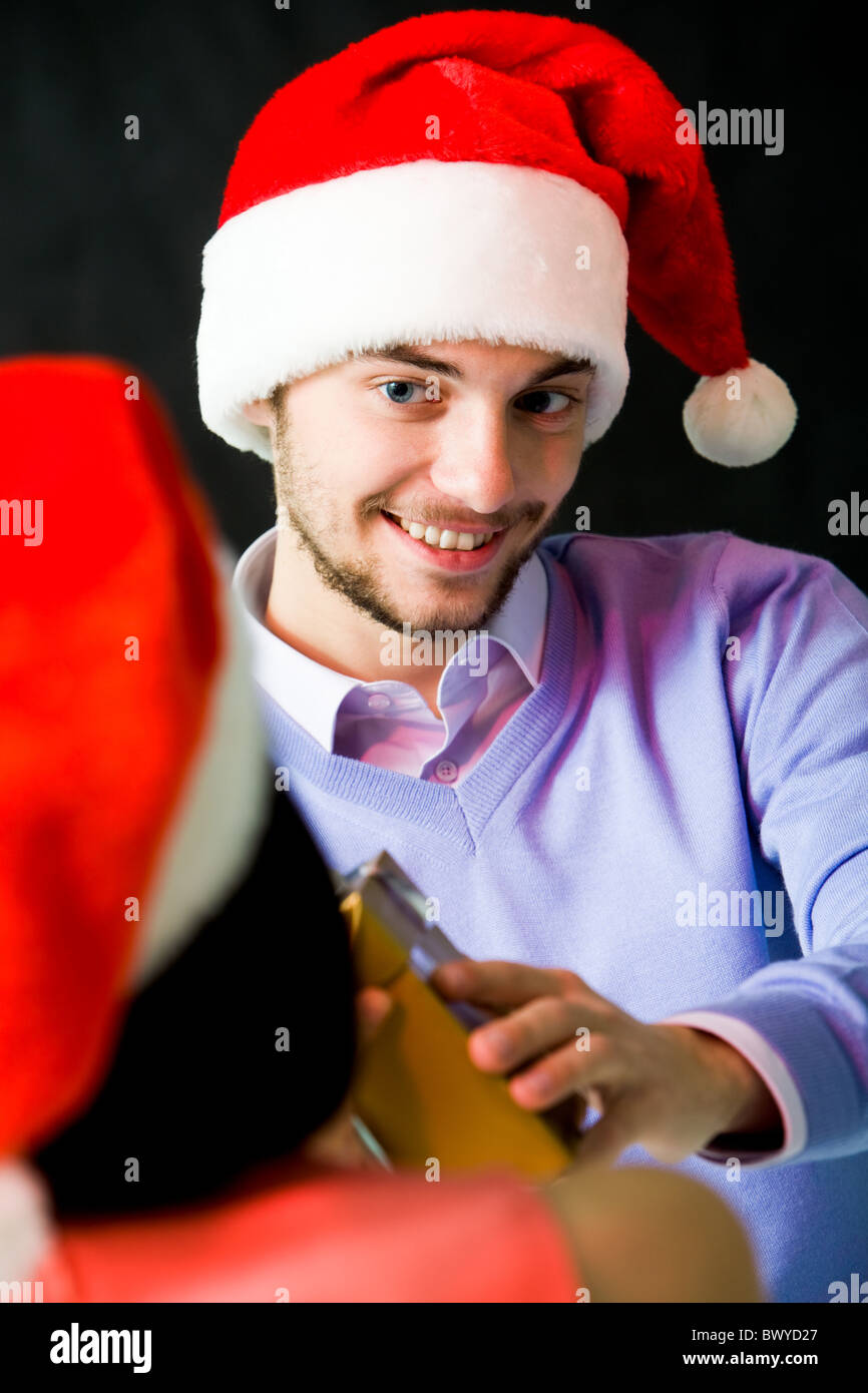 Handsome guy giving christmas present hi-res stock photography and ...