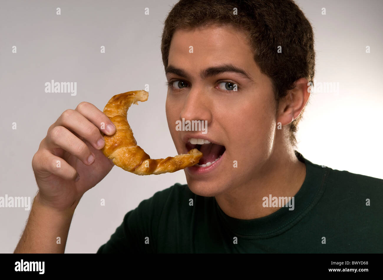Man eating a croissant Stock Photo - Alamy
