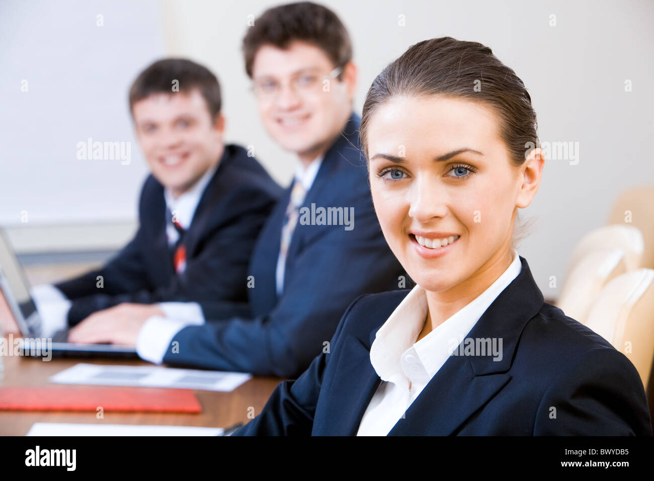 Image of attractive secretary with two men on background Stock Photo ...