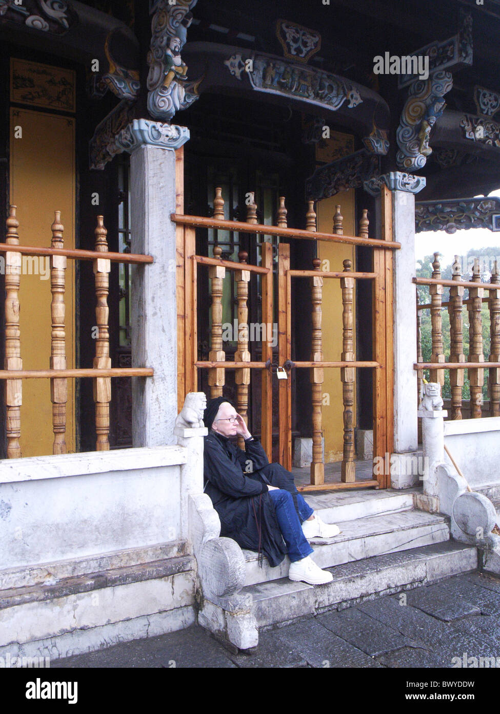 Caucasian tourist resting in front of the Chinese traditional ...