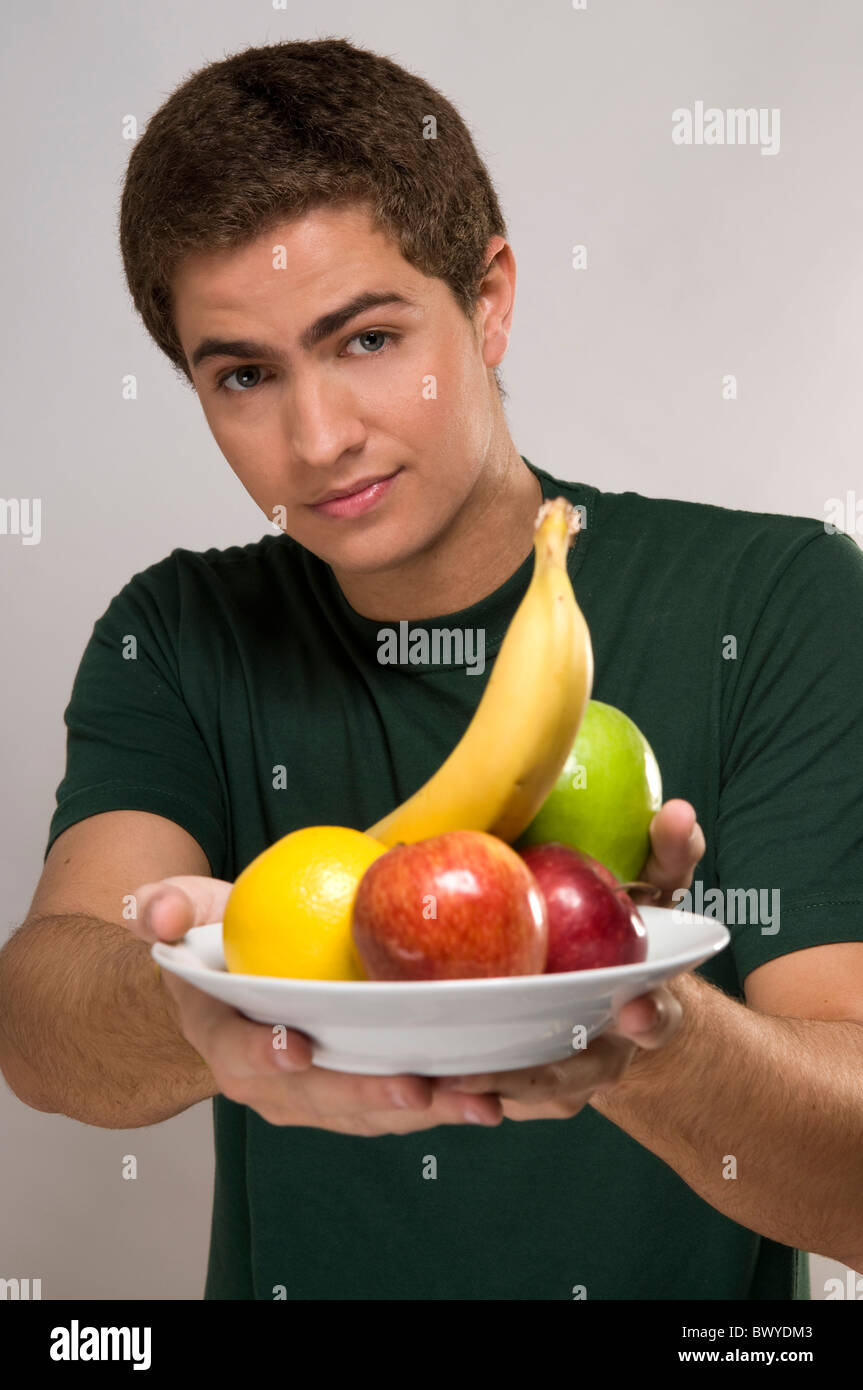 Man holding a plate of fruits Stock Photo - Alamy