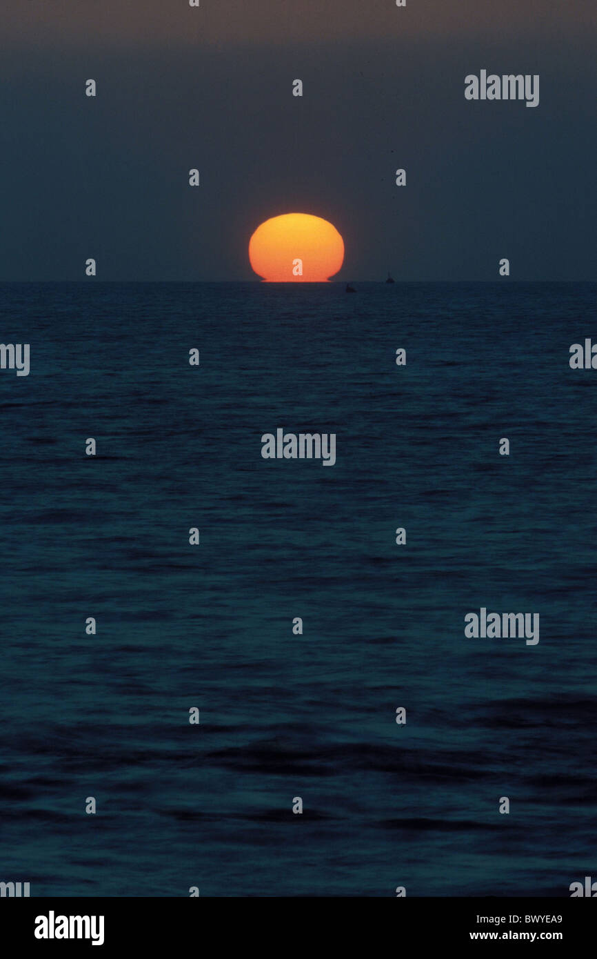 ball dusk mood sea ships sphere sundown sun twilight water Stock Photo ...