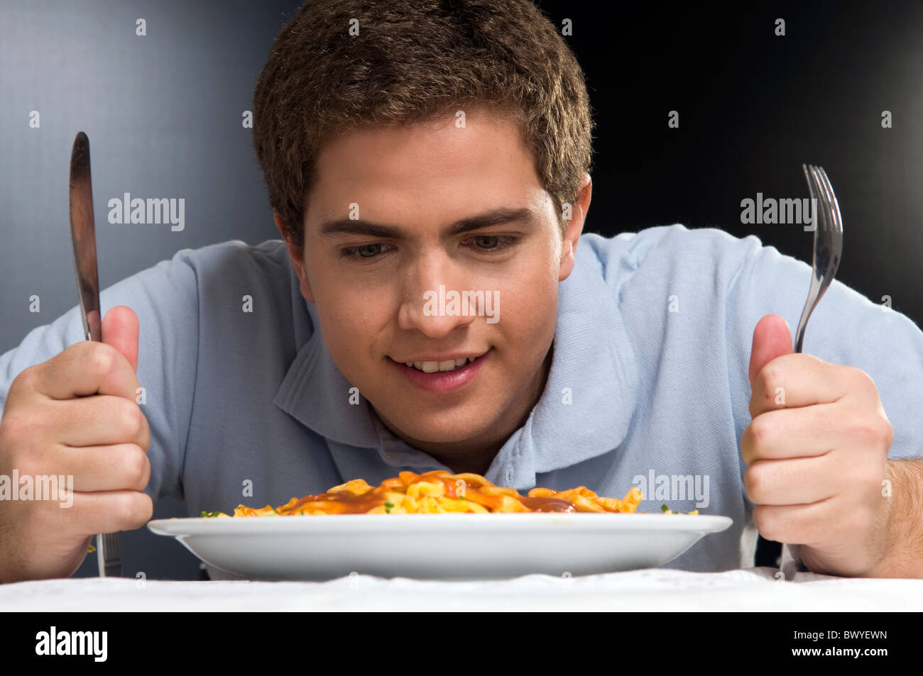 Man with a plate of pasta Stock Photo - Alamy
