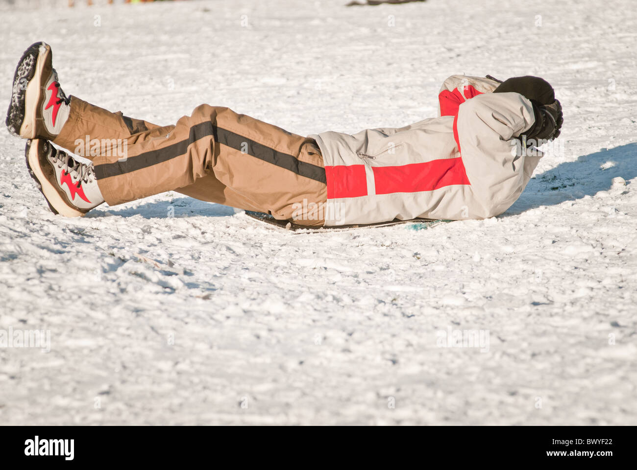 Man having a nap in the snow Stock Photo - Alamy