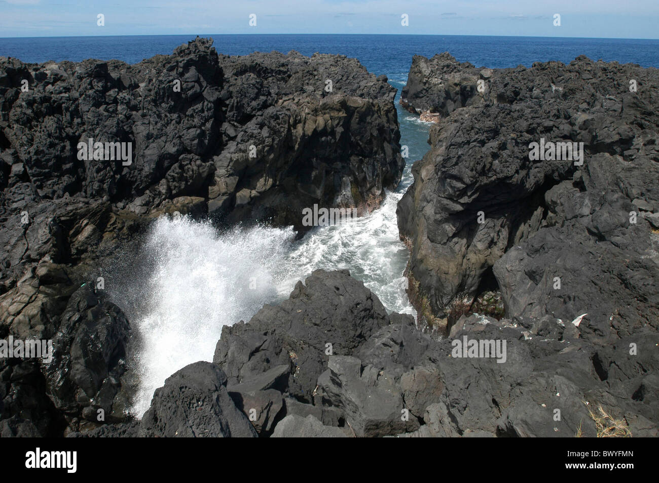 basalt surf waves cliff coast Ile de la Reunion Indian ocean coast Le ...