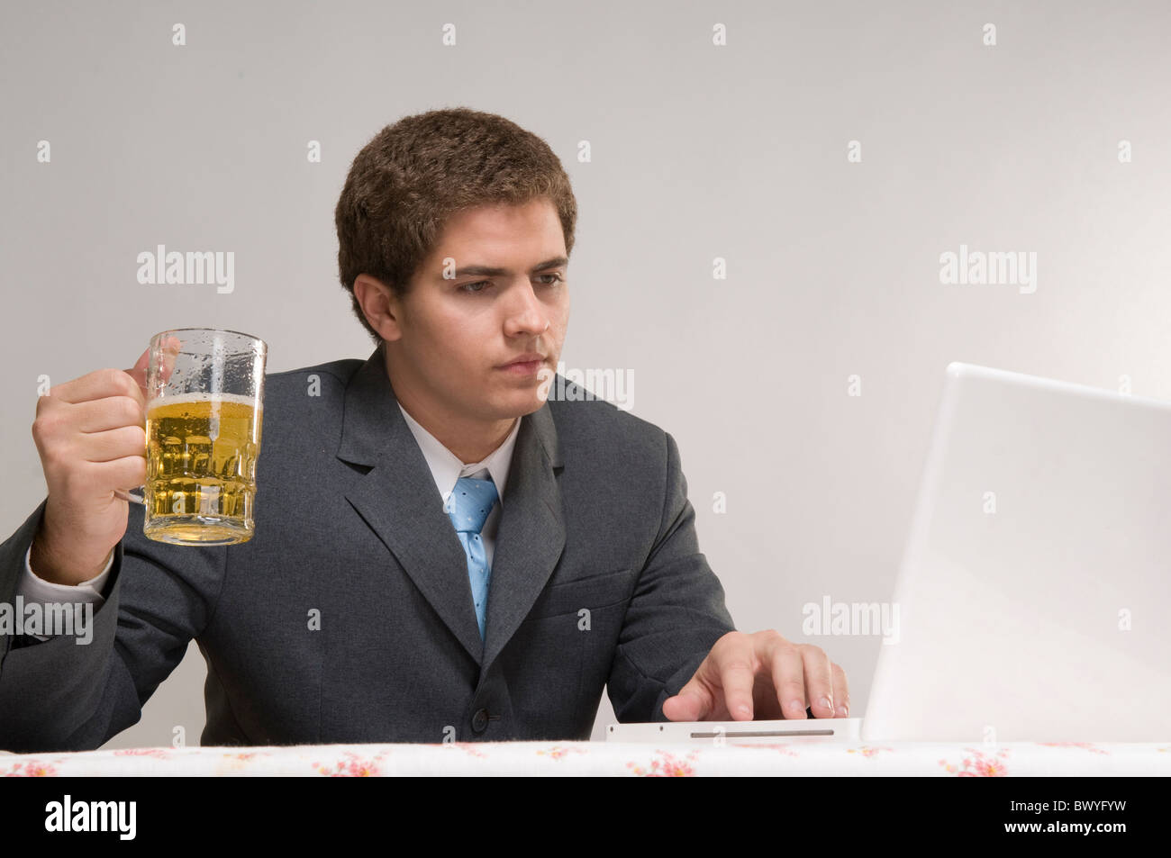 Man drinking beer with a laptop Stock Photo - Alamy