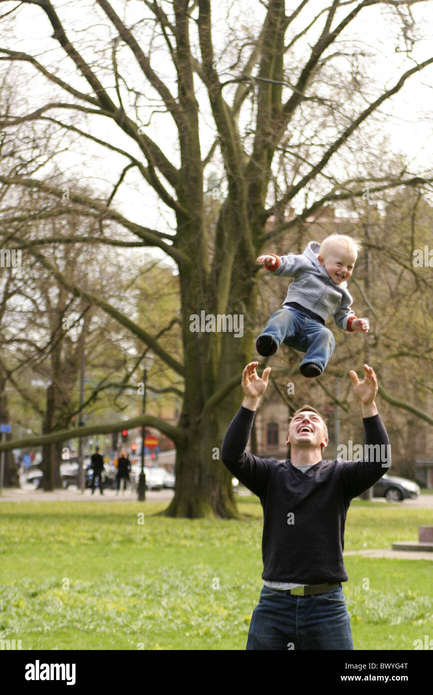 Man throwing child into air and catching him Stock Photo - Alamy