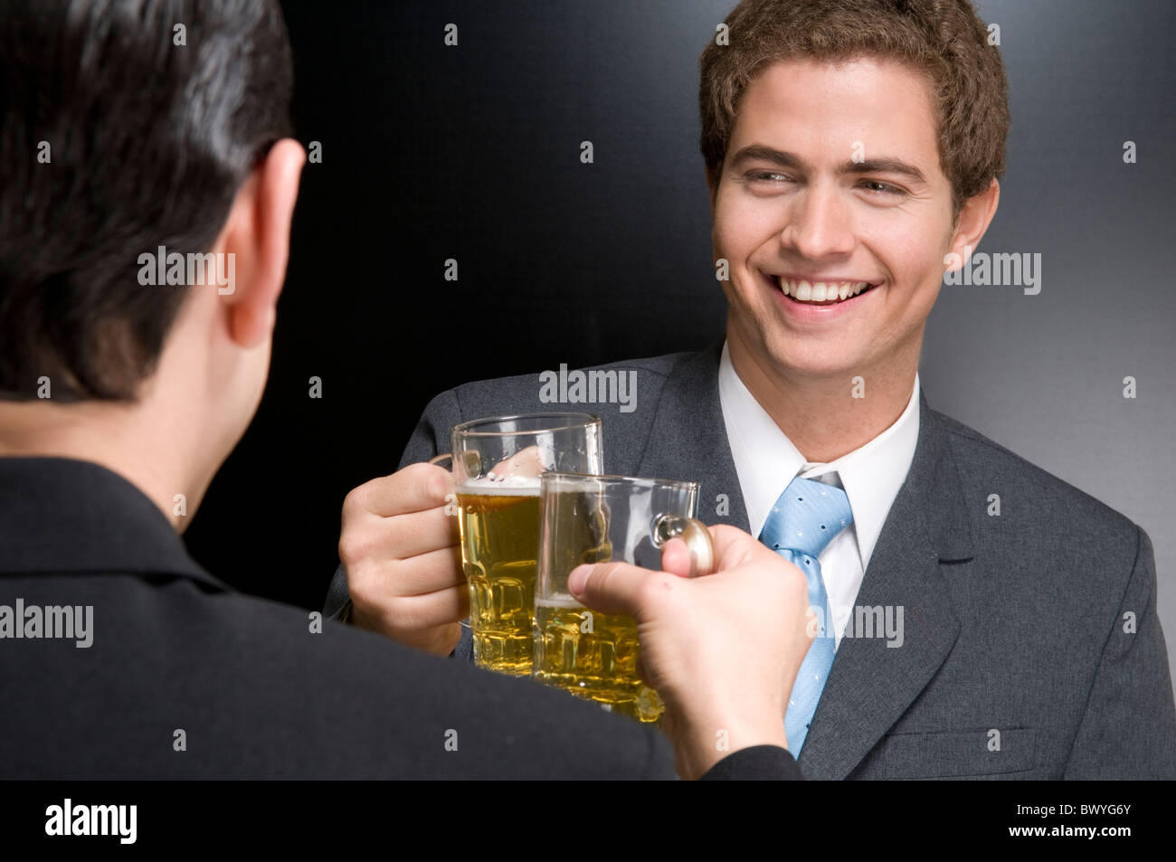 Businessmen toasting with beer Stock Photo - Alamy