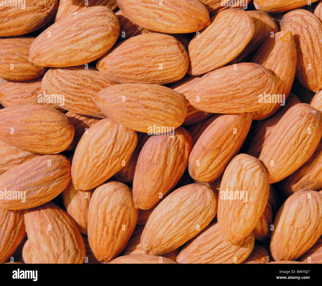 nuts almonds peeled heaps cutting part picture-filling concept nut food ...