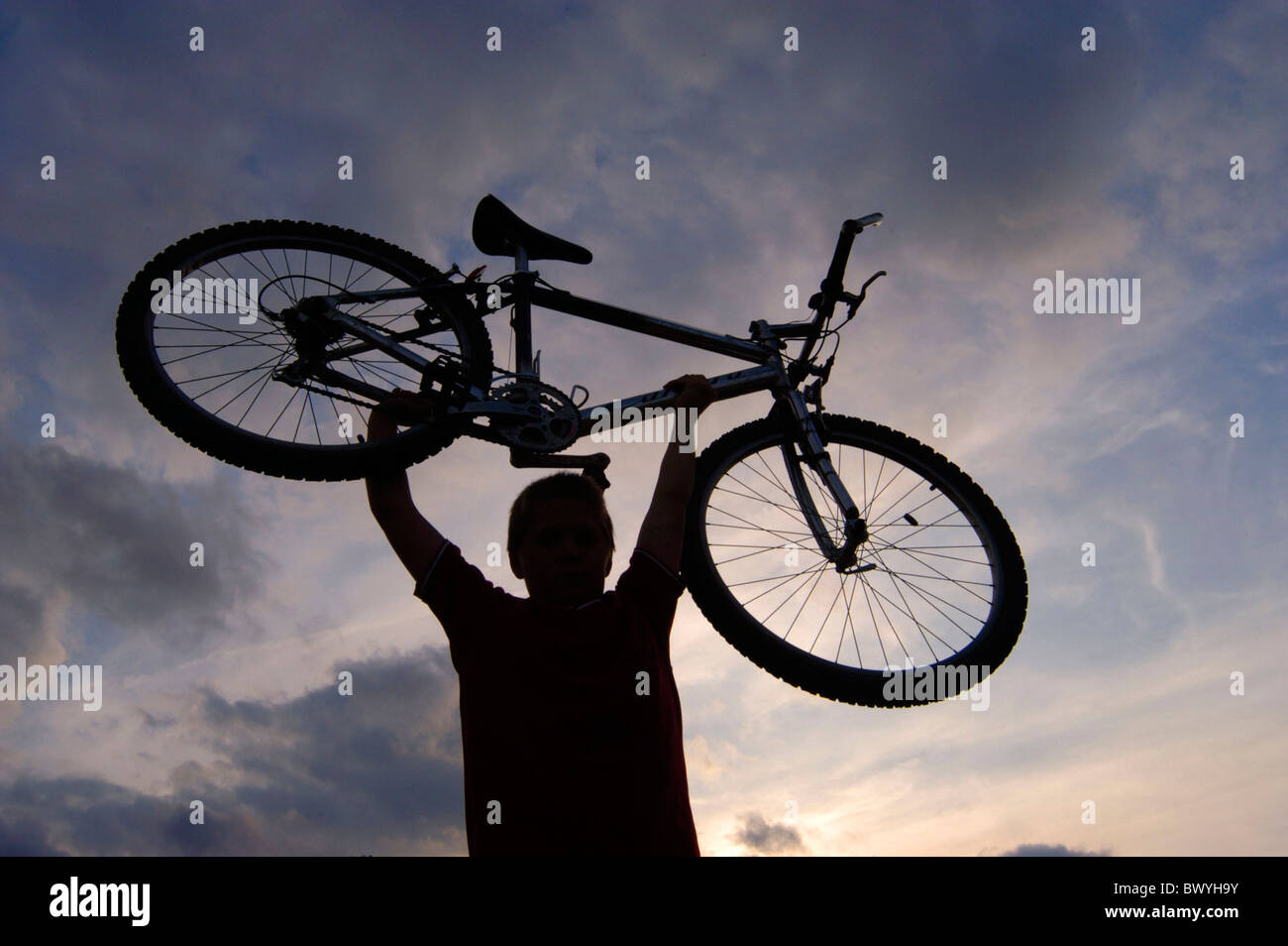 bicycle bike biking boy child dusk mood mountain bike holding up ...