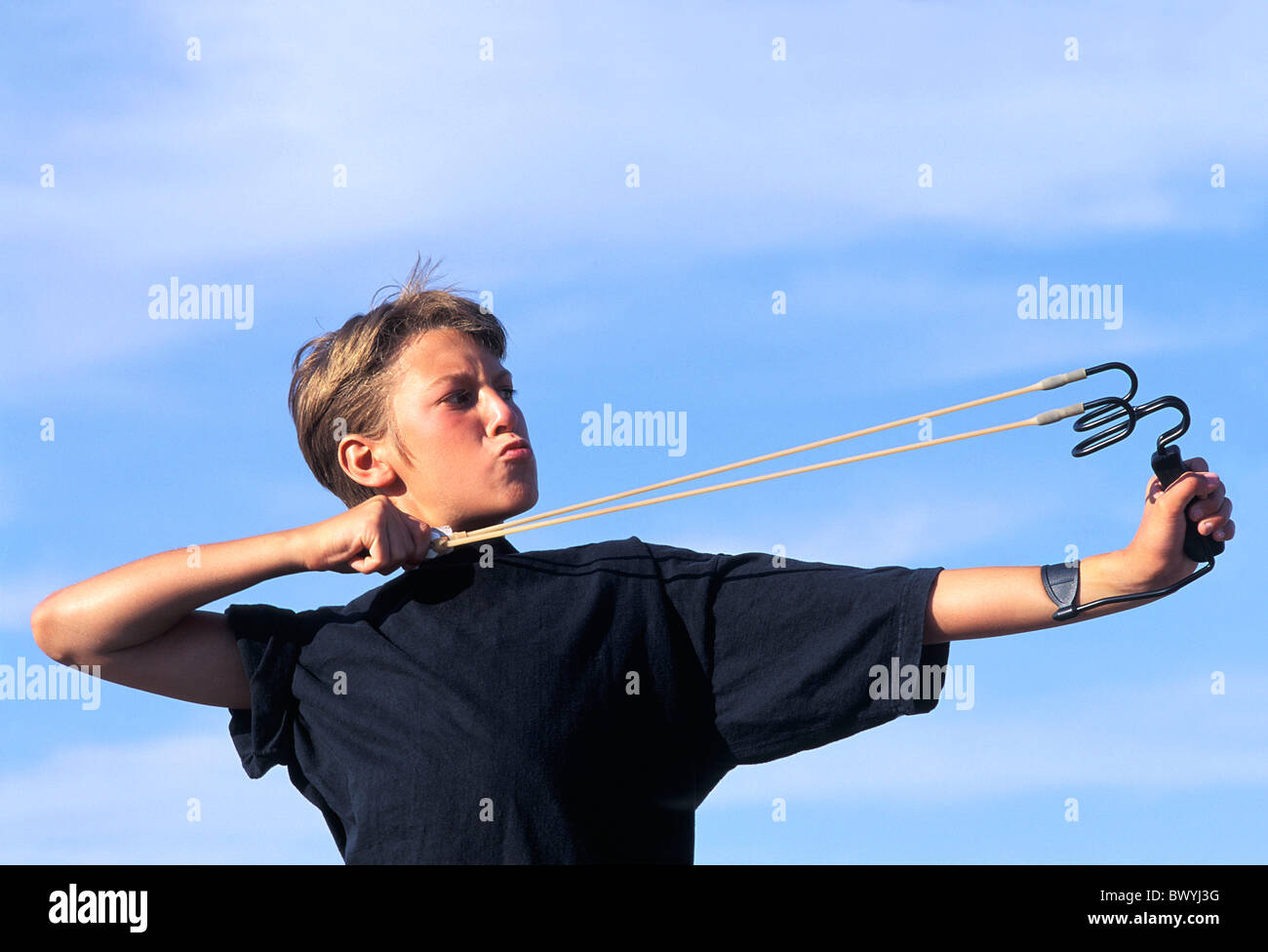 aim boy catapult Child outside prank scamp sky slingshot Stock Photo ...