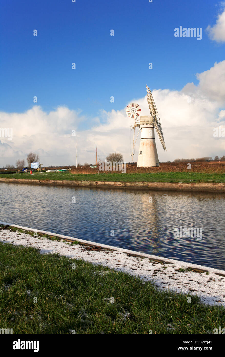 Thurne Mill and reflection on the Norfolk Broads in winter set against ...