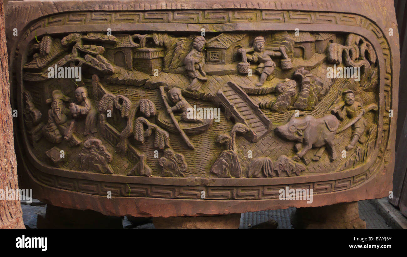 Wooden plaque carved with patterns depicting daily life in ancient ...