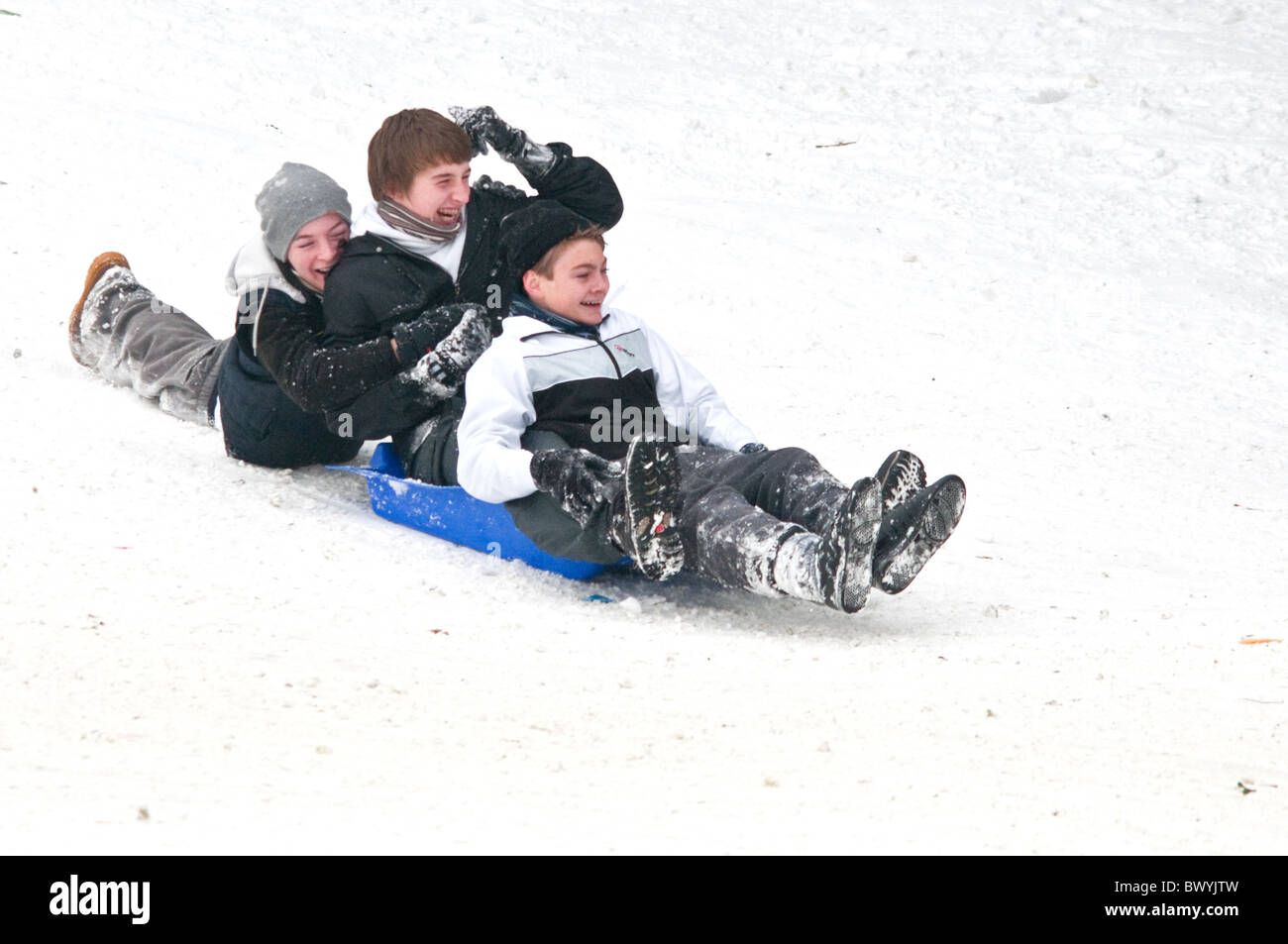 Boys riding on sled Stock Photo - Alamy