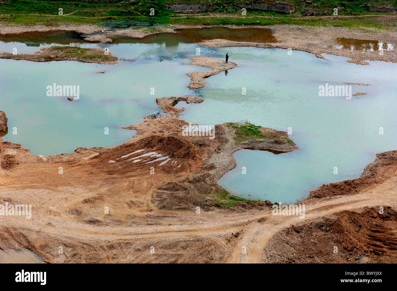 Man fishing in shallow river, Damaopo, Guangyuan, Sichuan Province ...