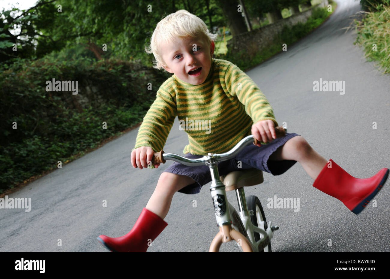 Child riding balance bike Stock Photo - Alamy
