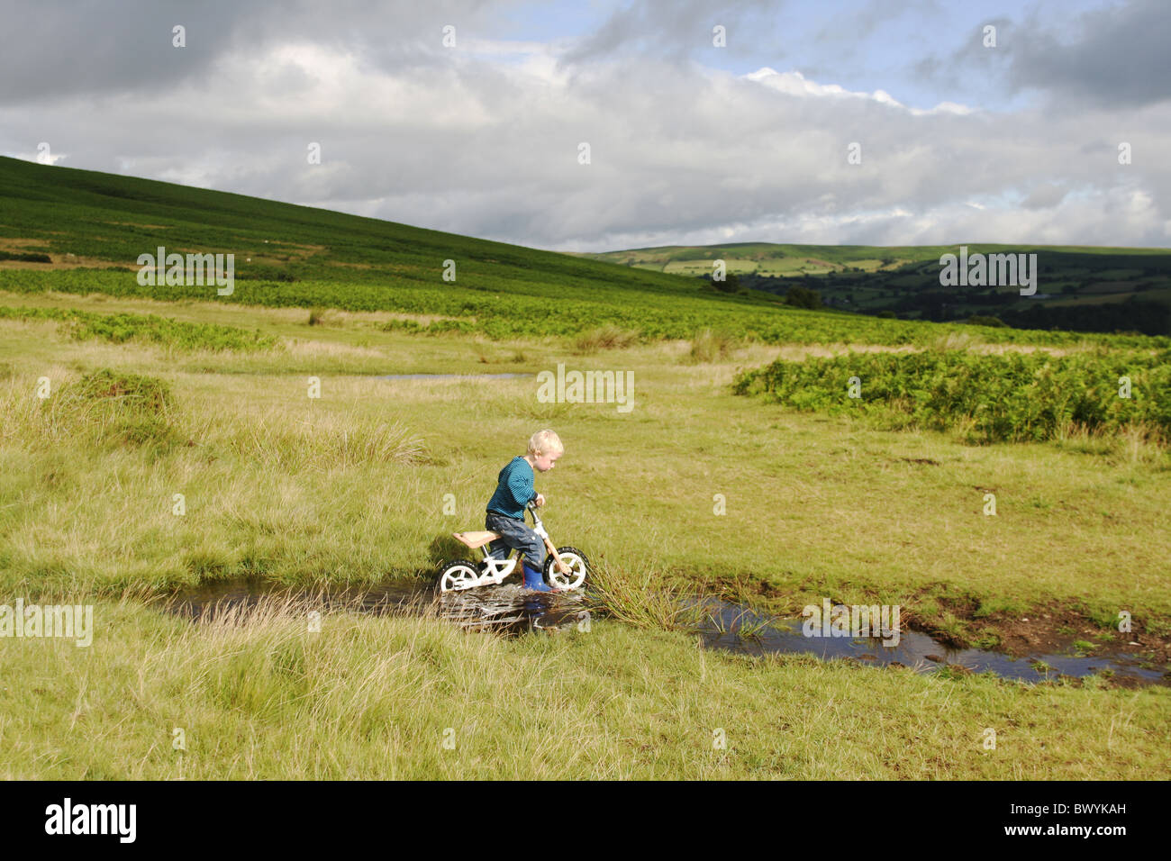 Boy riding bike on mountain Stock Photo - Alamy