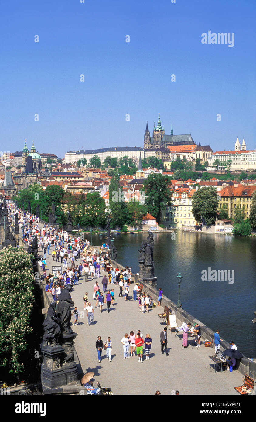 river flow Moldavia Hradcany Charles bridge pedestrian passerby Prague Prague castle town city ...