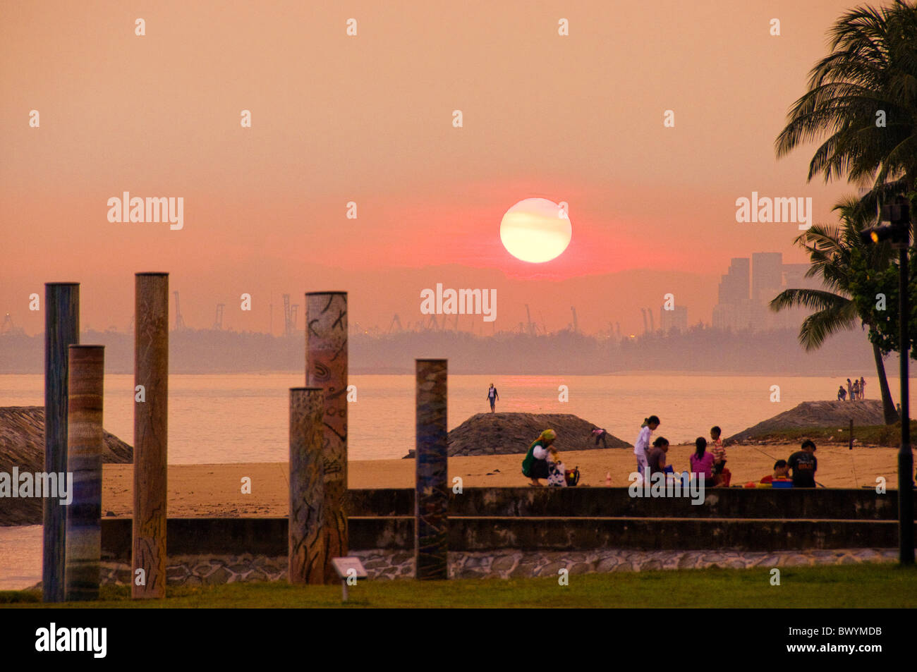 Tropical sunset with pier and water in foreground Stock Photo - Alamy