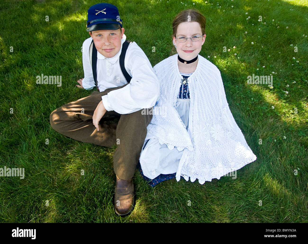 Young girl, 10, and boy, 12, wear clothing typical for a girl and boy ...