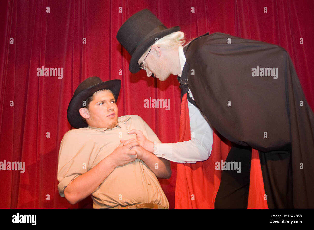 Scene from melodrama play set in 1800s where villain shouts at man ...