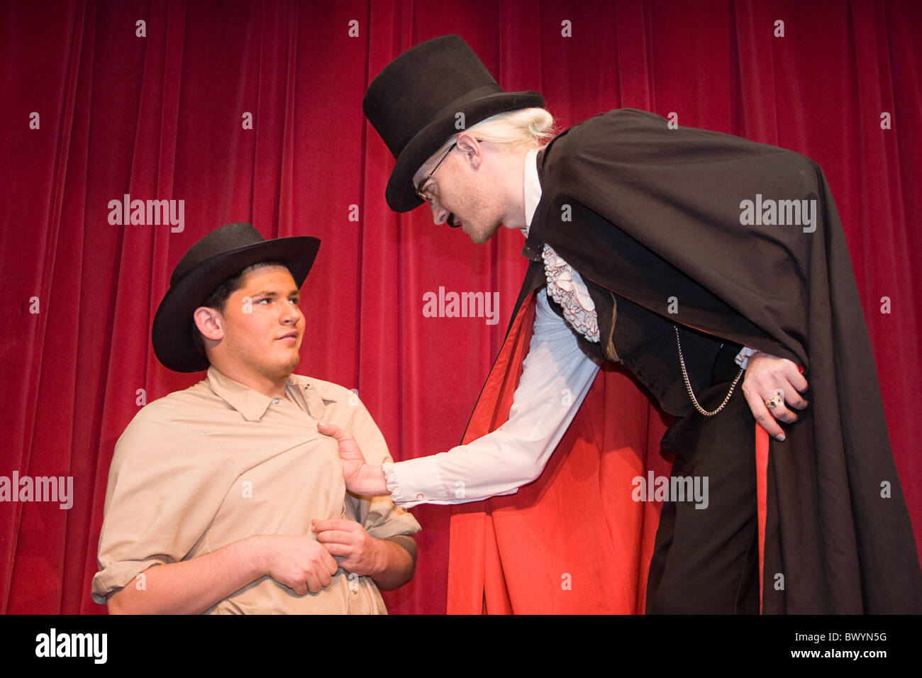 Scene from melodrama play set in 1800s where villain shouts at man ...