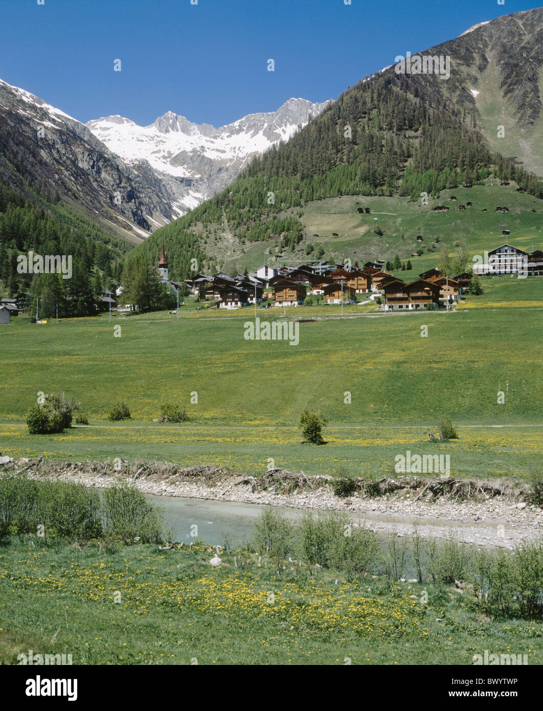 alpine Alps mountains village river flow Goms canton Valais scenery ...