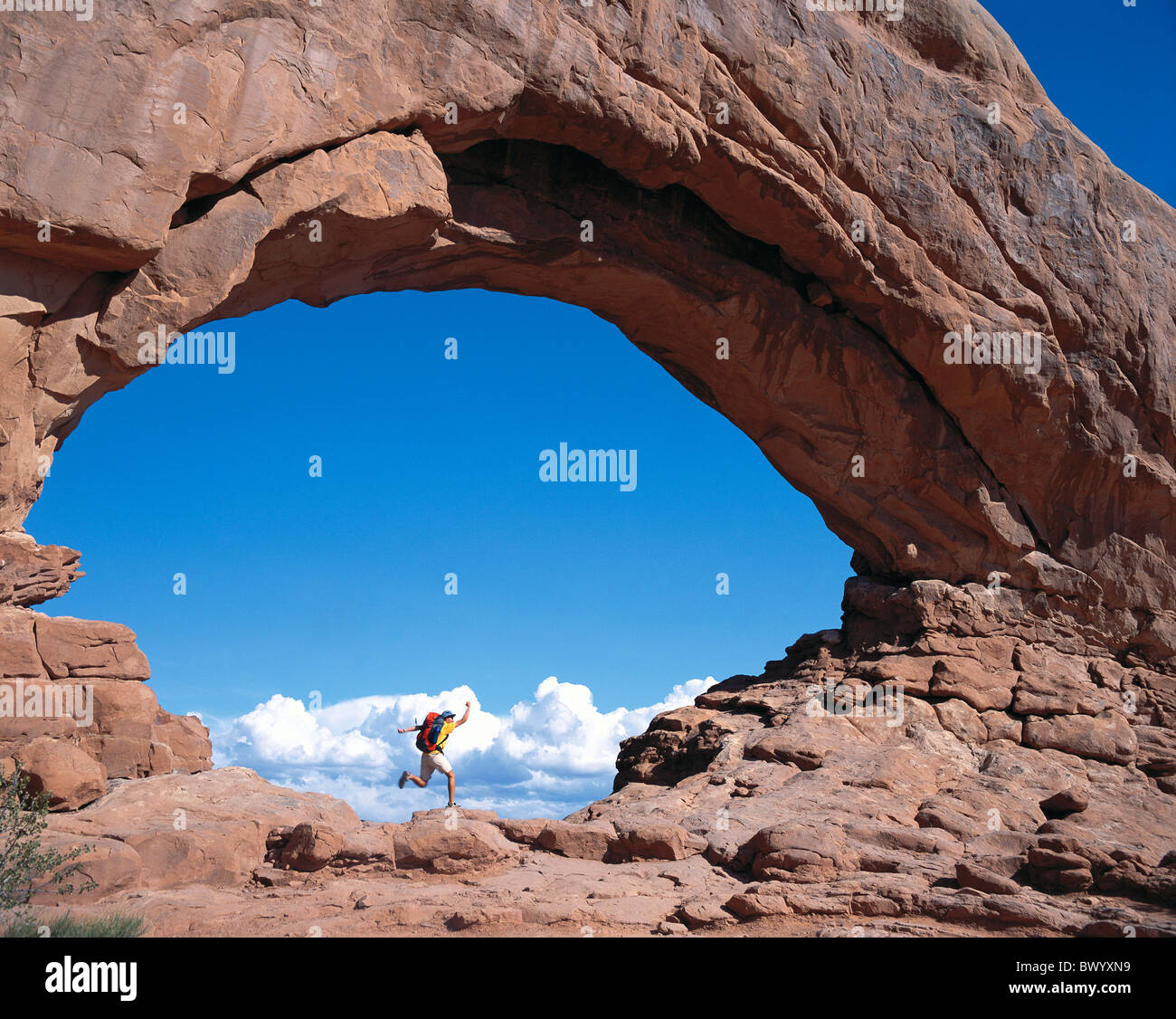 walking hiking Hiking action Arches national park cliff arch man ...