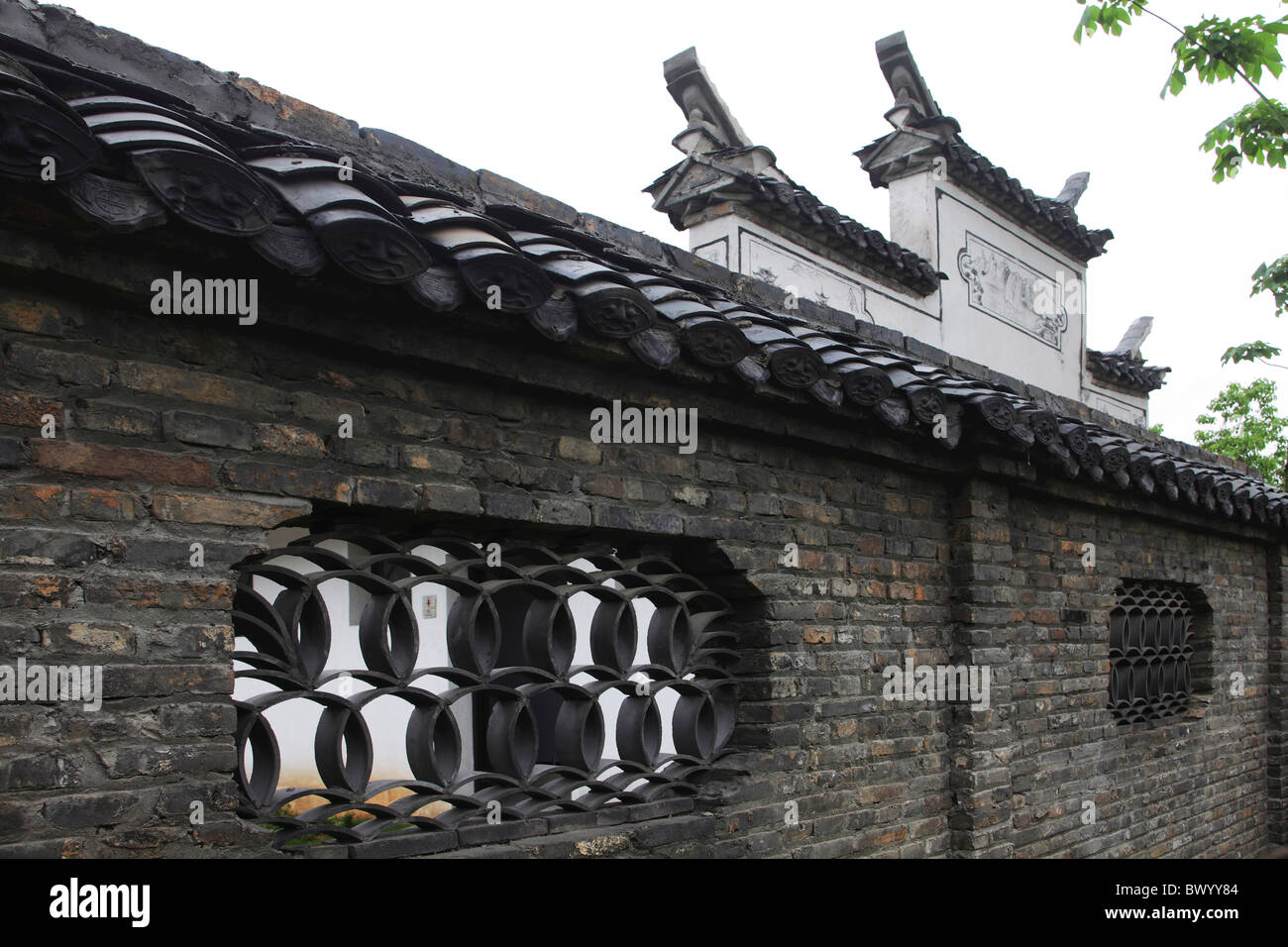 Brick wall with lattice window of a traditional Hui style home, Xinghua ...