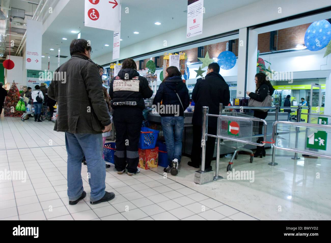 Person in row paying bagging at check-out cashier of Store supermarket ...