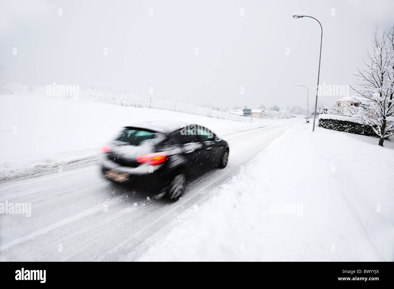 Car driving on a snowy road hi-res stock photography and images - Alamy