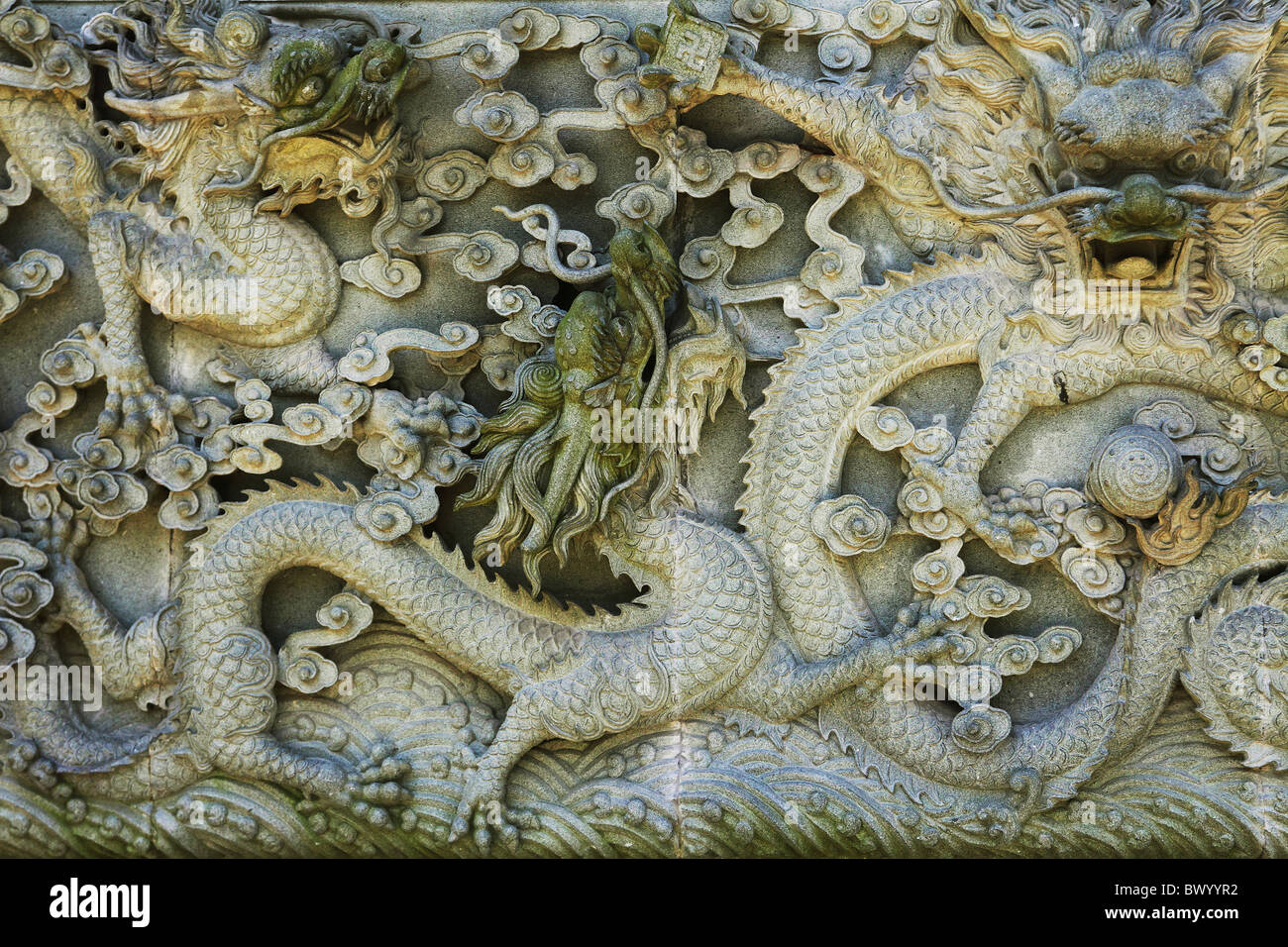 Elaborately carved stone dragon relief with cloud and ocean, Dayuan ...