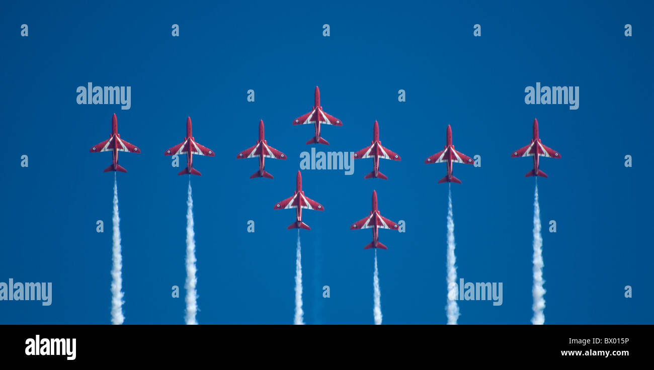 Red arrows hawks display team in arrow formation trailing white - blue ...