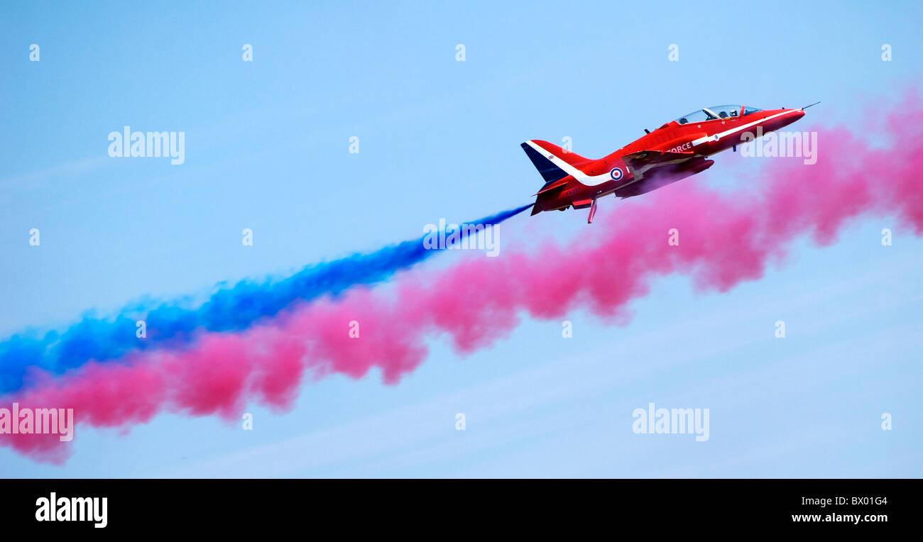 A single Red arrows hawk with display team trailing blue trailing smoke ...