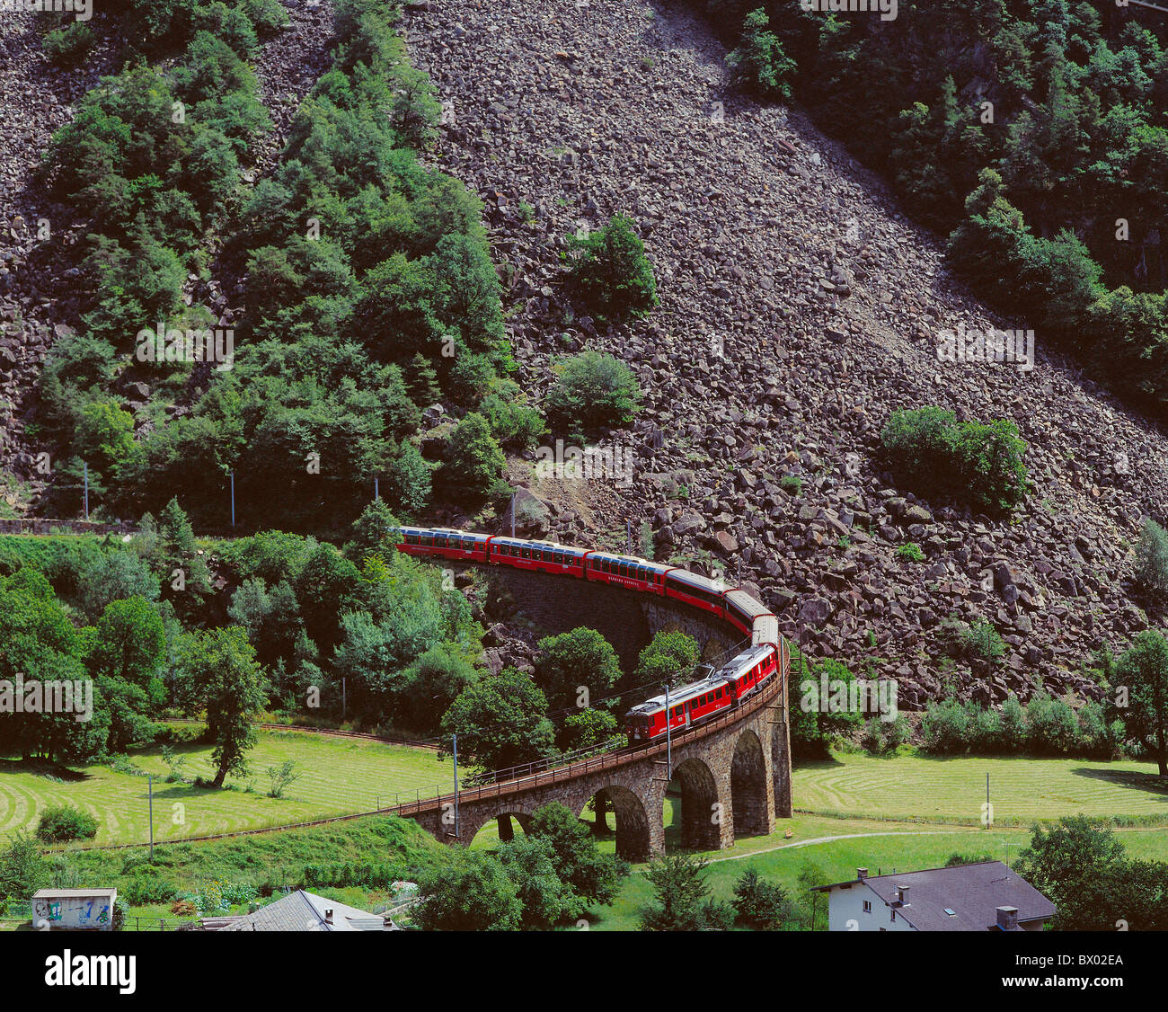 railway RhB Bernina express train bridge curve mountain slope stone ...