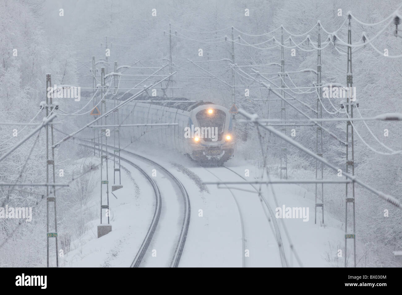 Train passing through winter landscape Stock Photo - Alamy