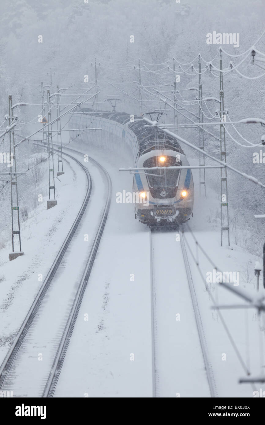 Train passing through winter landscape Stock Photo - Alamy