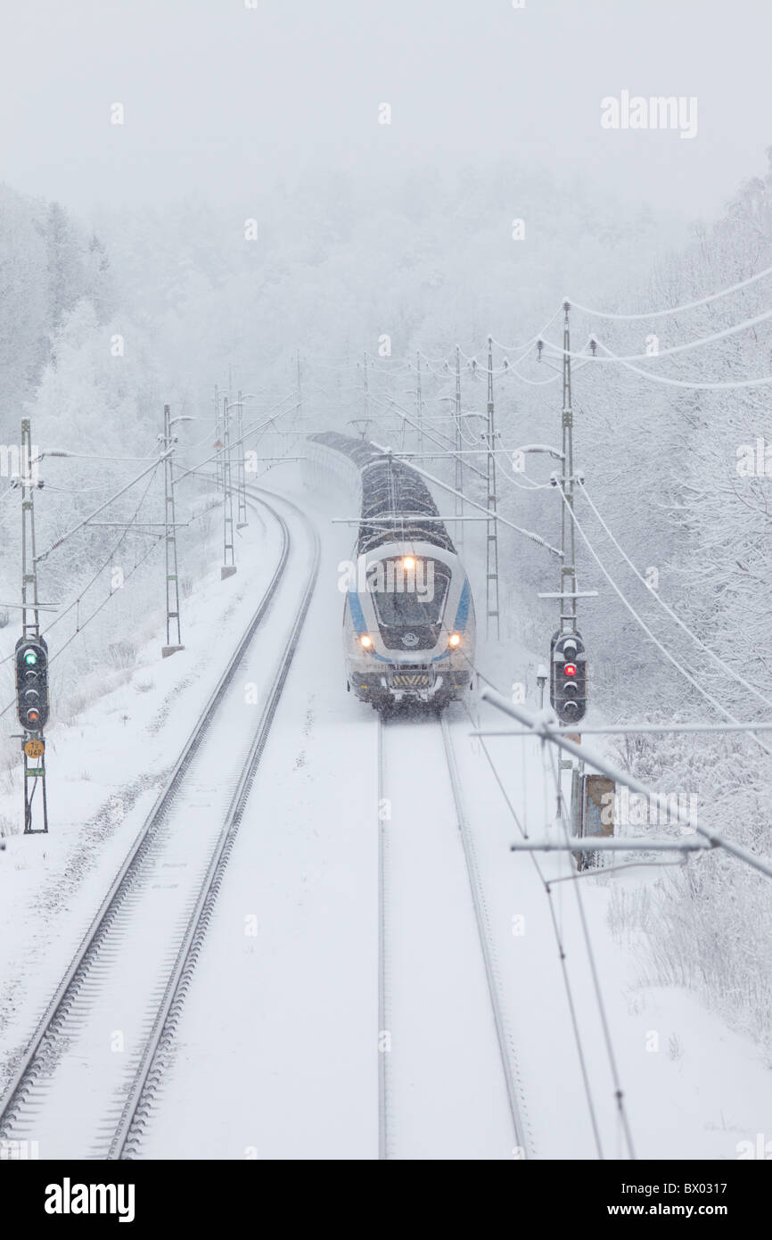 Train passing through winter landscape Stock Photo - Alamy