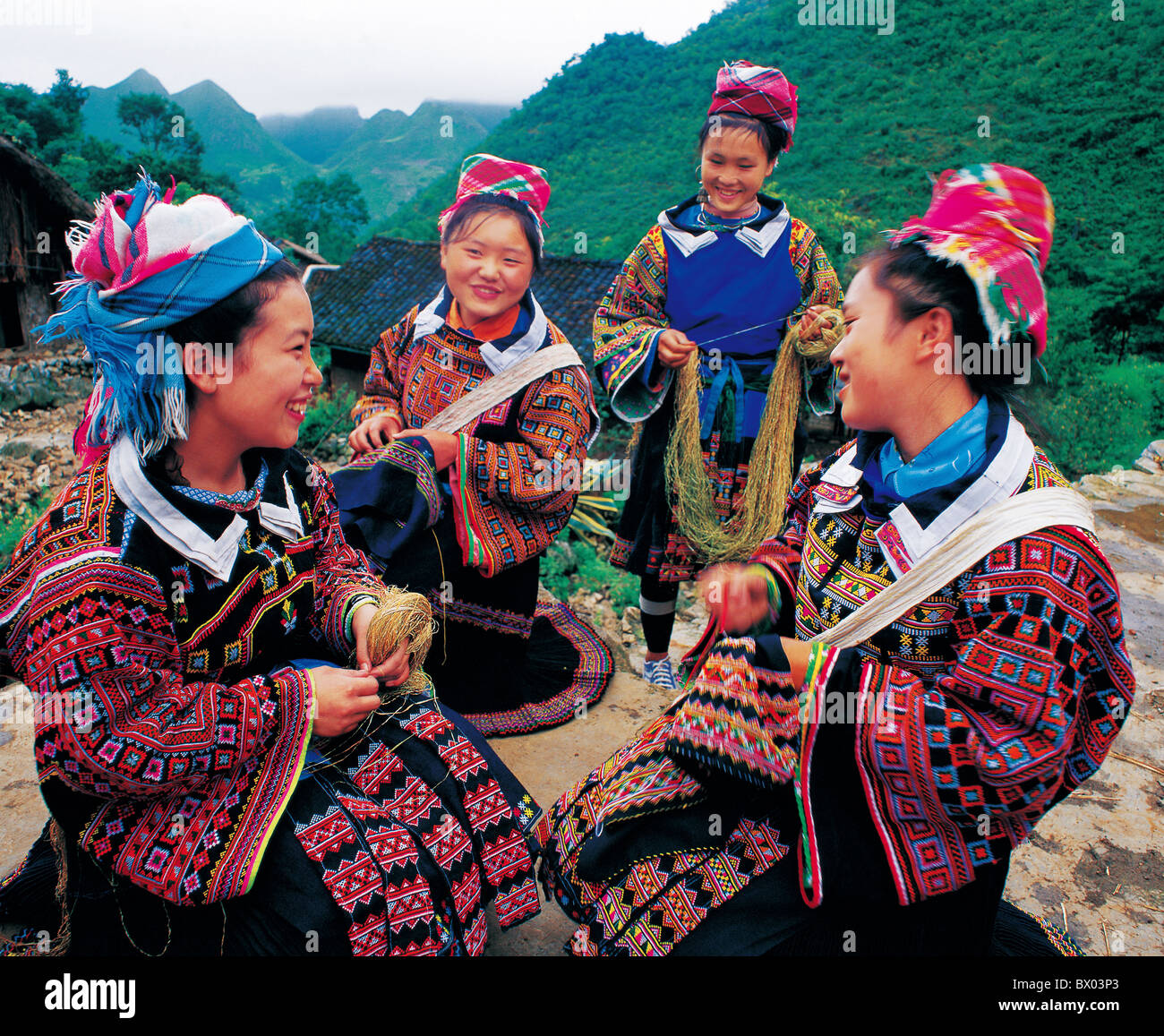 Su Miao women in traditional costume organizing thread, Dawantun ...