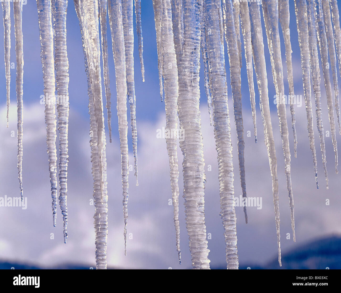 winter icicle row picture-filling concept ice plug Stock Photo - Alamy