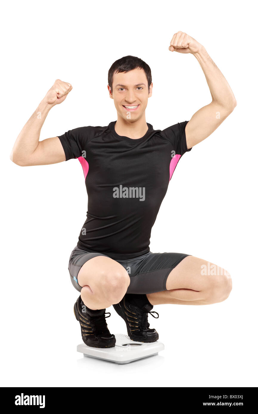A young happy athlete on a weight scale Stock Photo - Alamy