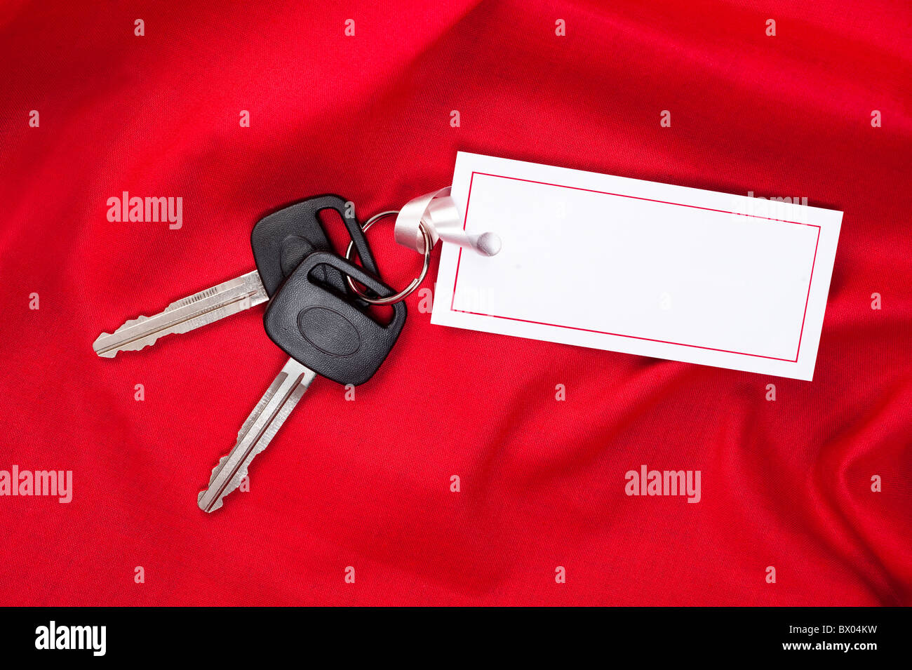 A set of new car keys with ribbon attached to a blank card for copy ...