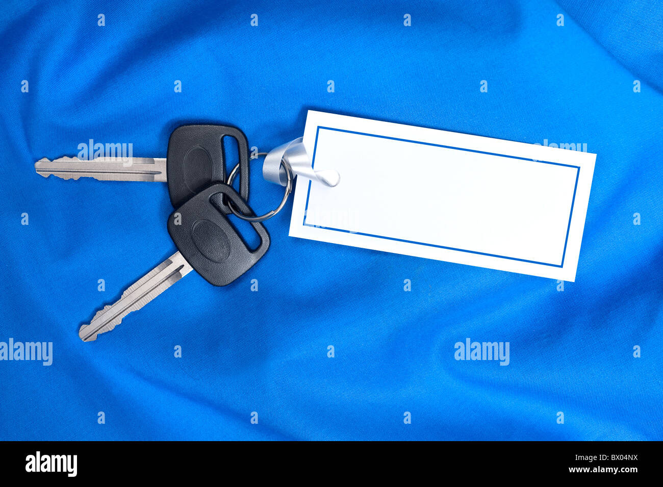 A set of new car keys with ribbon attached to a blank card for copy ...